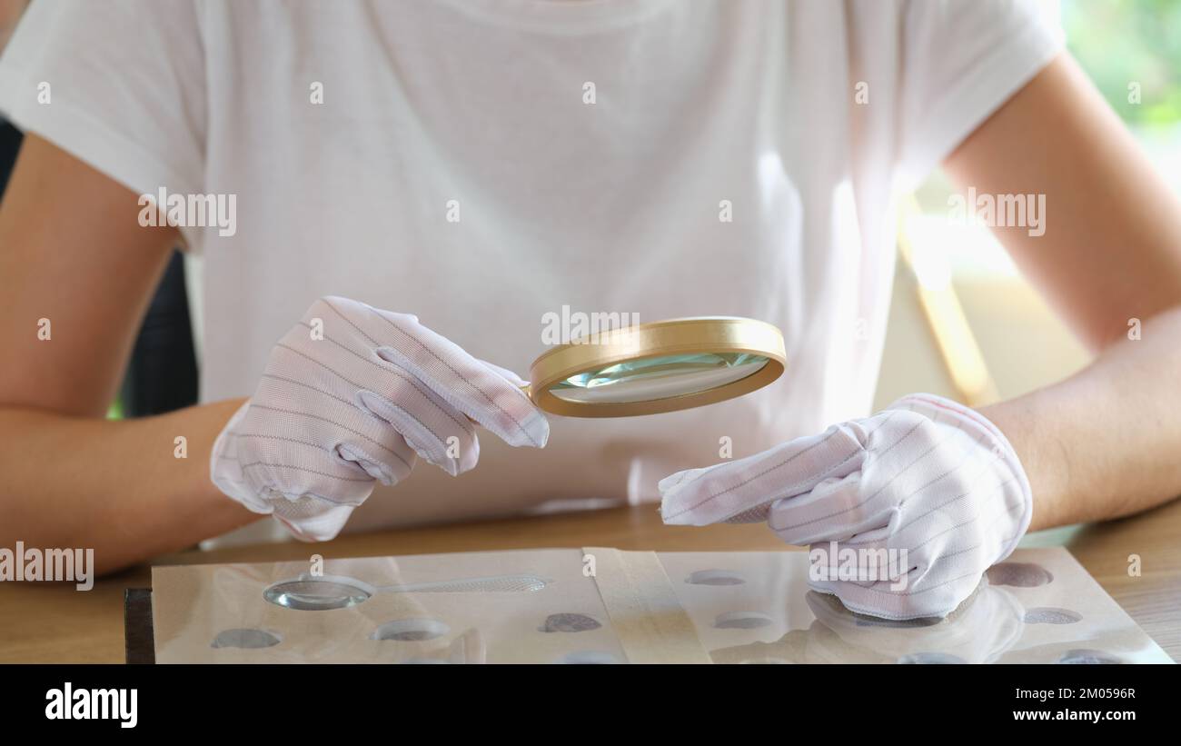 Numismatist in gloves magnifying glass hi-res stock photography and ...