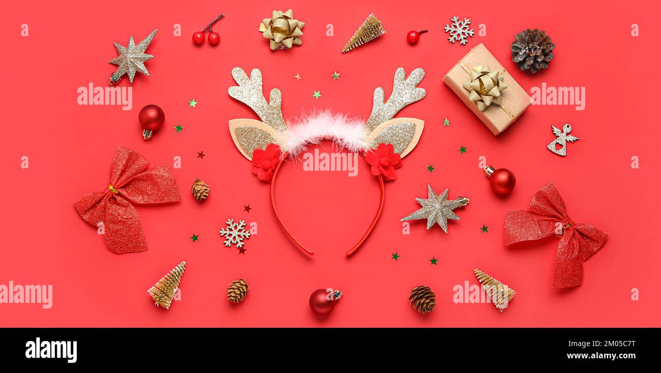 Christmas reindeer horns with decorations and gift on red background ...