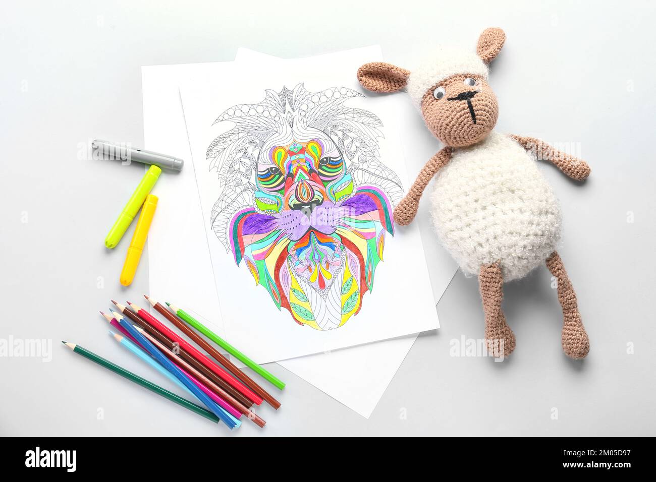 Coloring page, felt-tip pens, pencils and toy on light background Stock ...