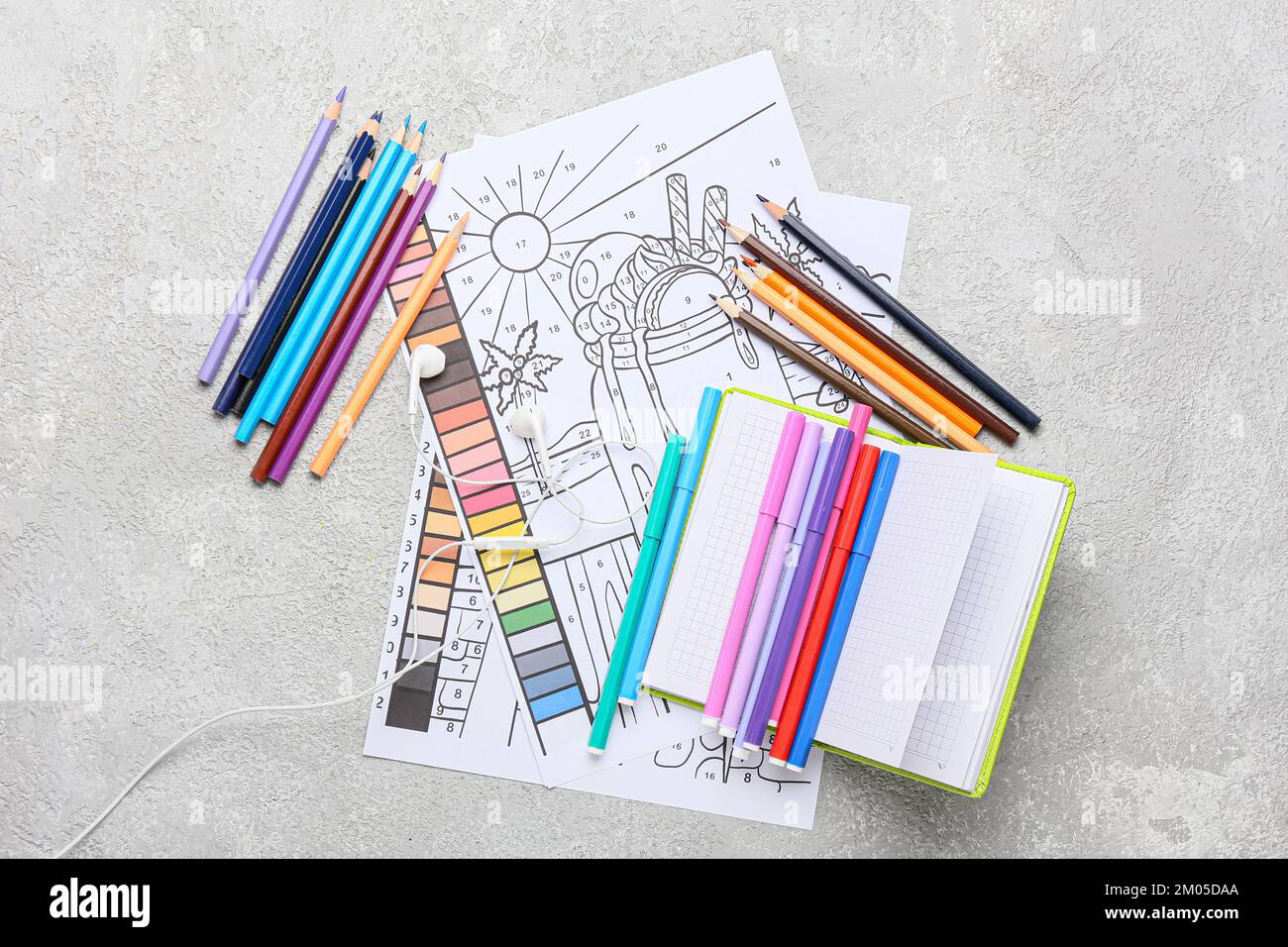 Coloring pages, felt-tip pens, pencils and notebook on grunge ...