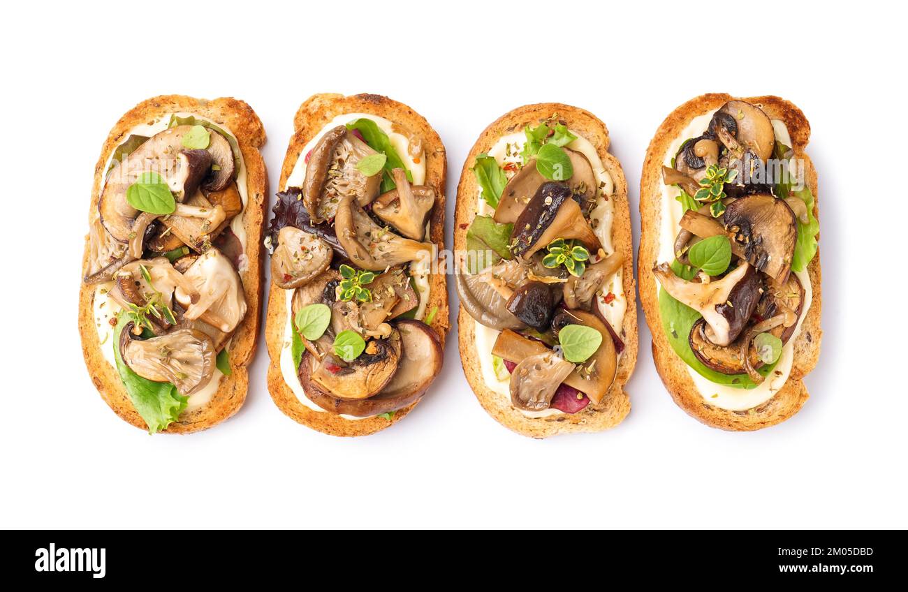 Tasty toasts with cream cheese and mushrooms on white background Stock ...