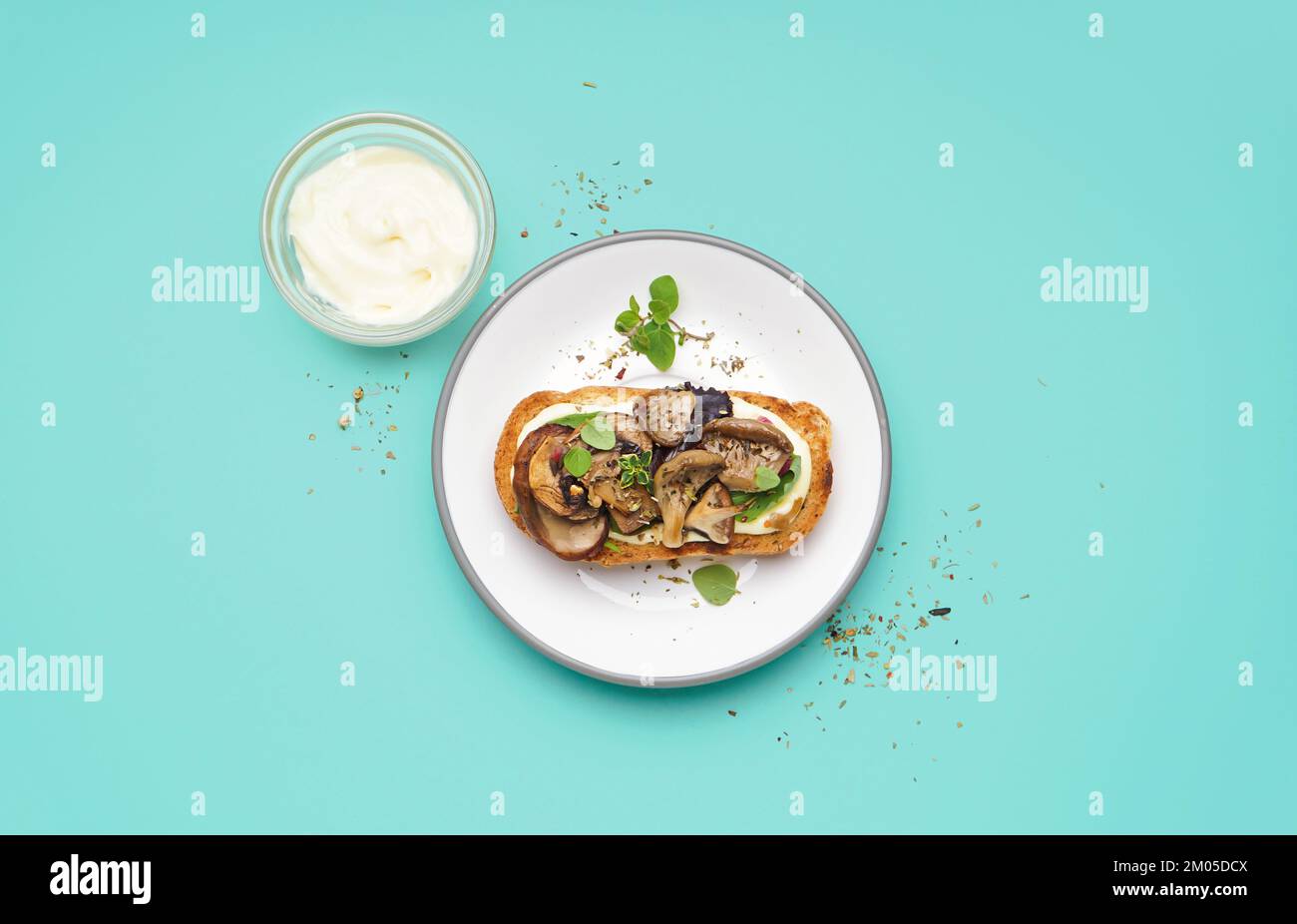 Plate of tasty toast with cream cheese and mushrooms on blue background ...