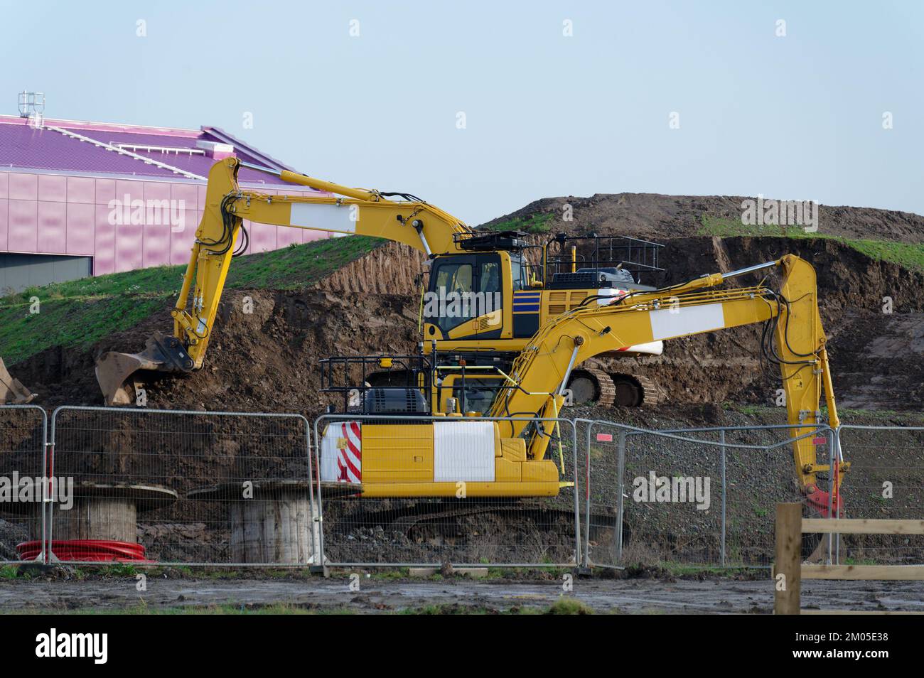 Construction site digger yellow during excavation on building site ...