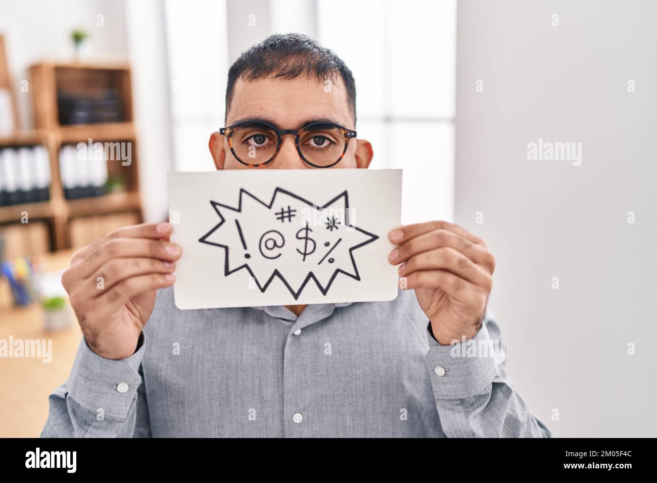 Middle east man with beard holding banner with swear words in shock ...