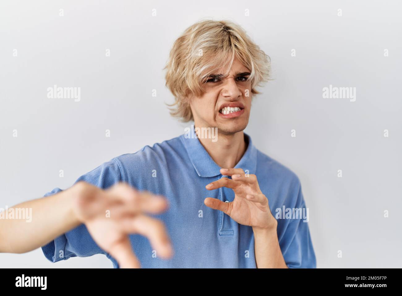 Young modern man standing over isolated background disgusted expression ...