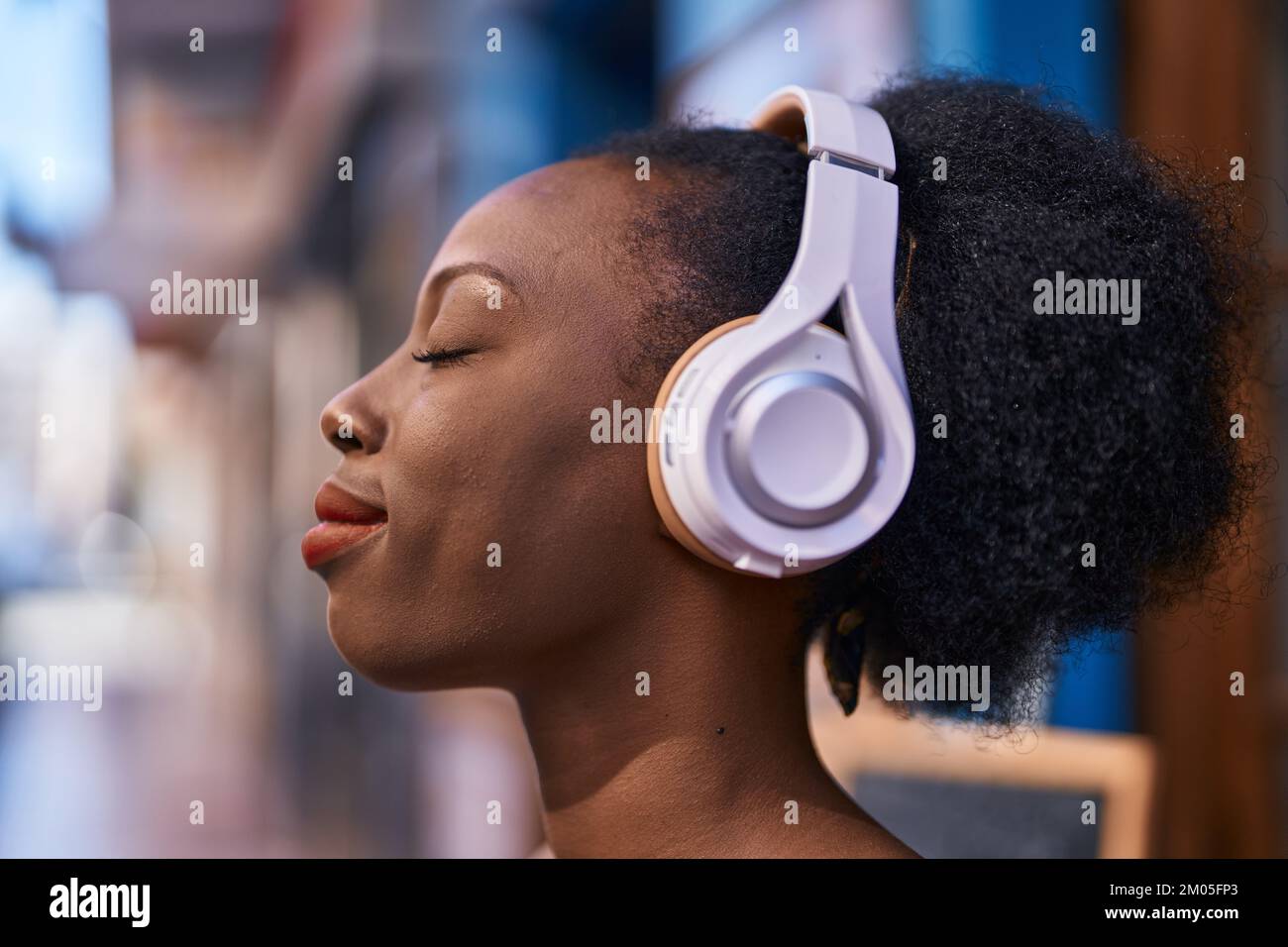 African american woman relaxed listening to music at street Stock Photo ...