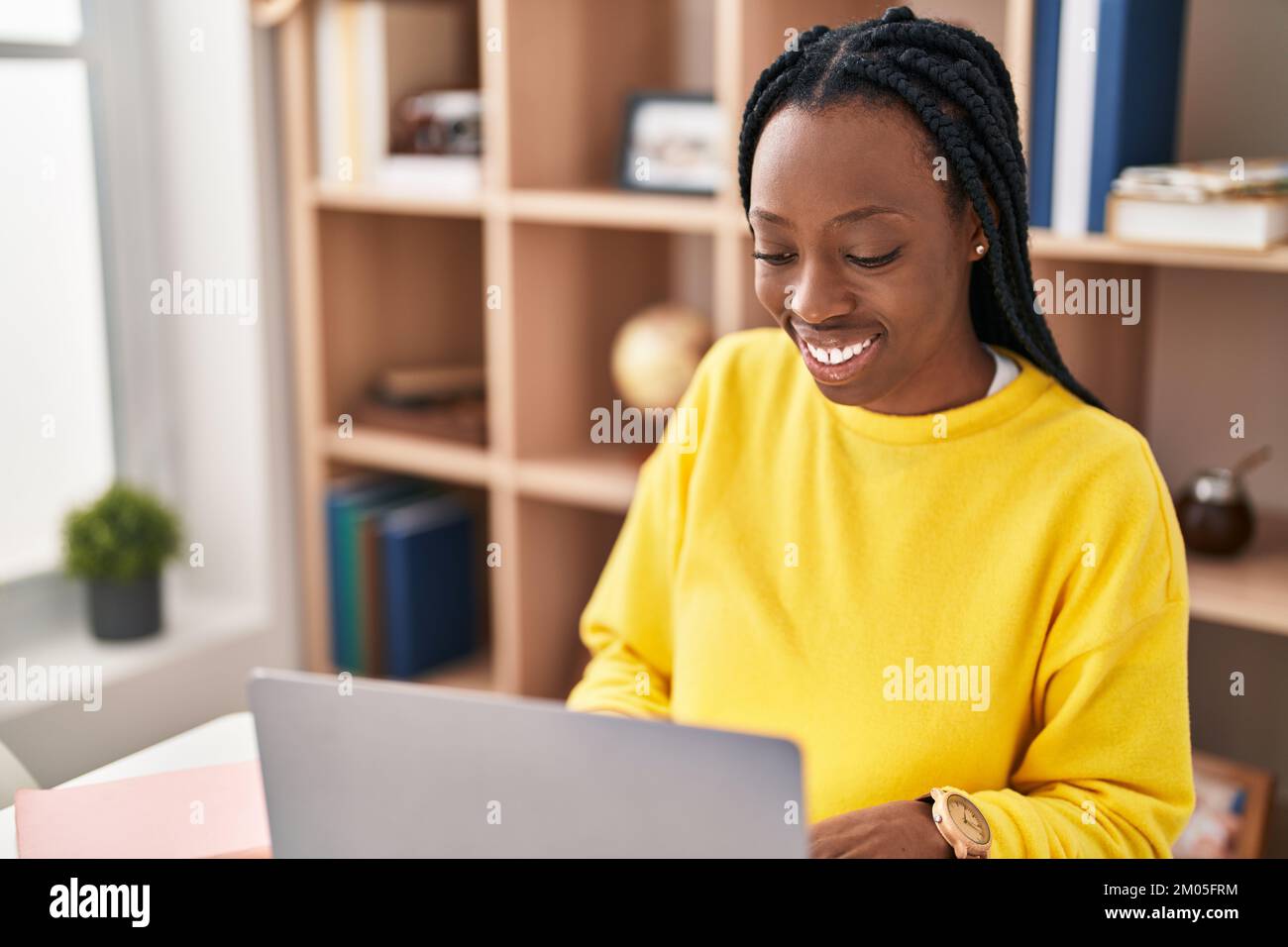 African american woman using laptop sitting on table at home Stock ...