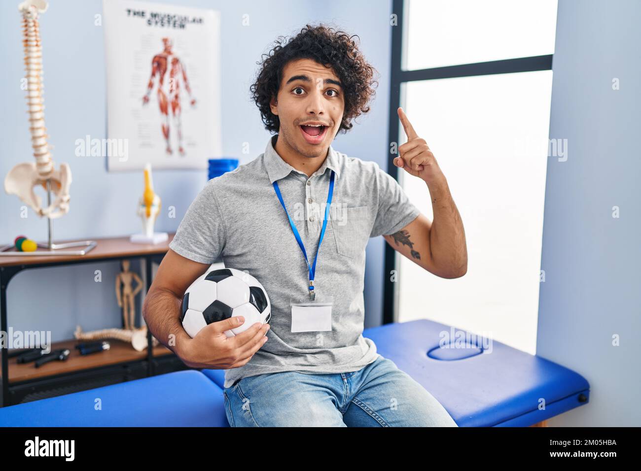 Hispanic man with curly hair working as football physiotherapist ...