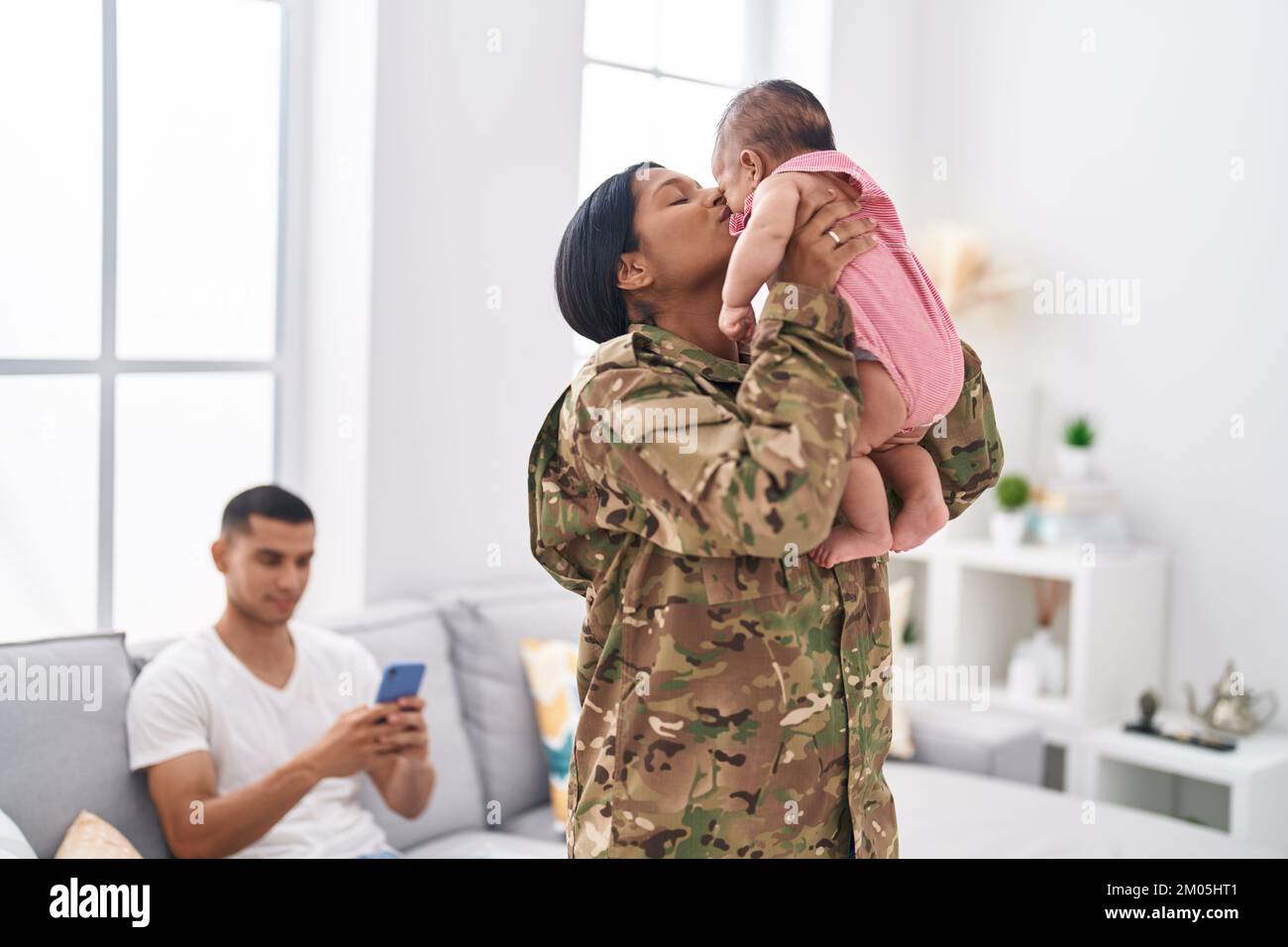 Hispanic family army soldier hugging each other at home Stock Photo - Alamy