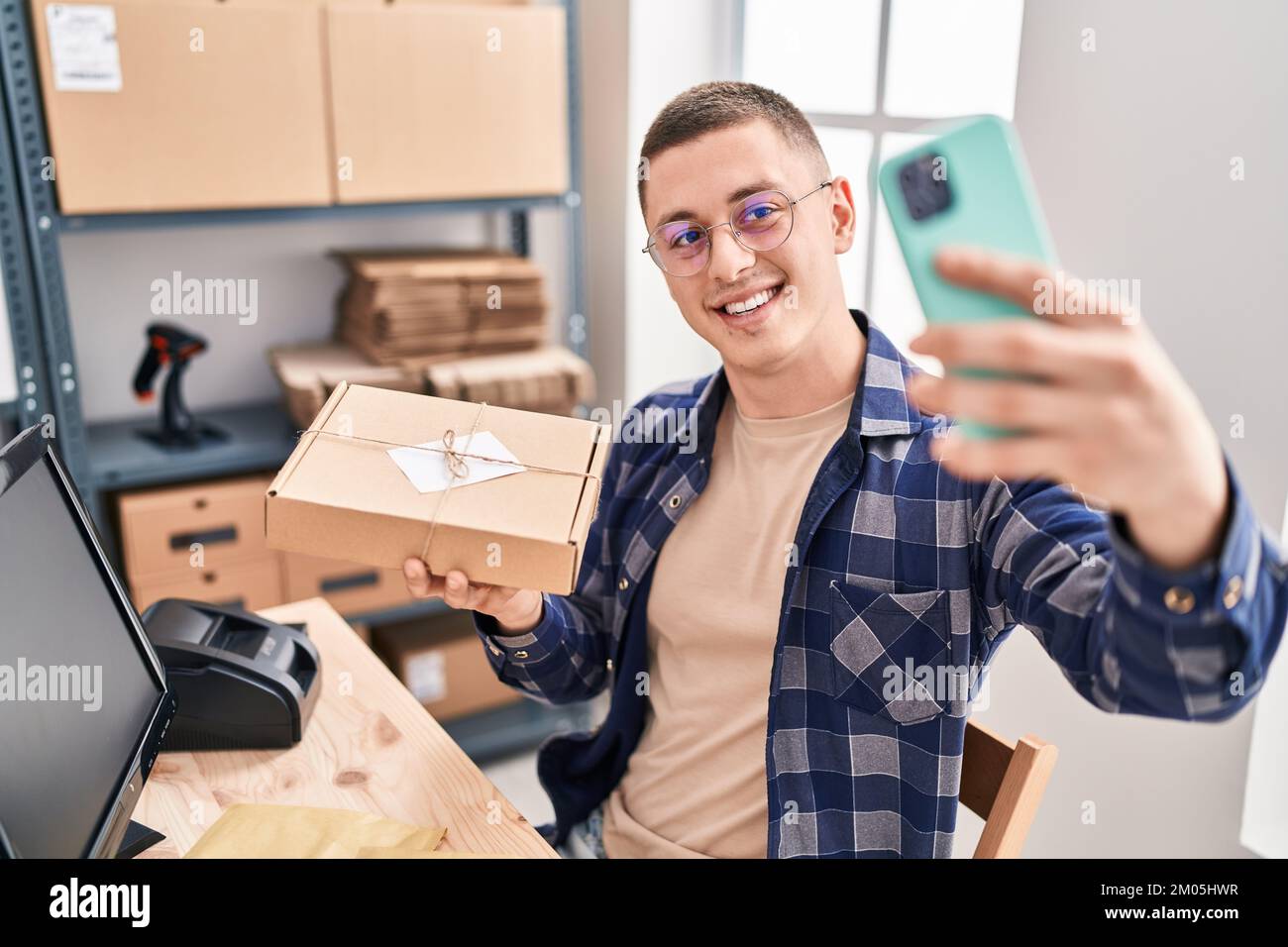 Young hispanic man ecommerce business worker make selfie holding ...