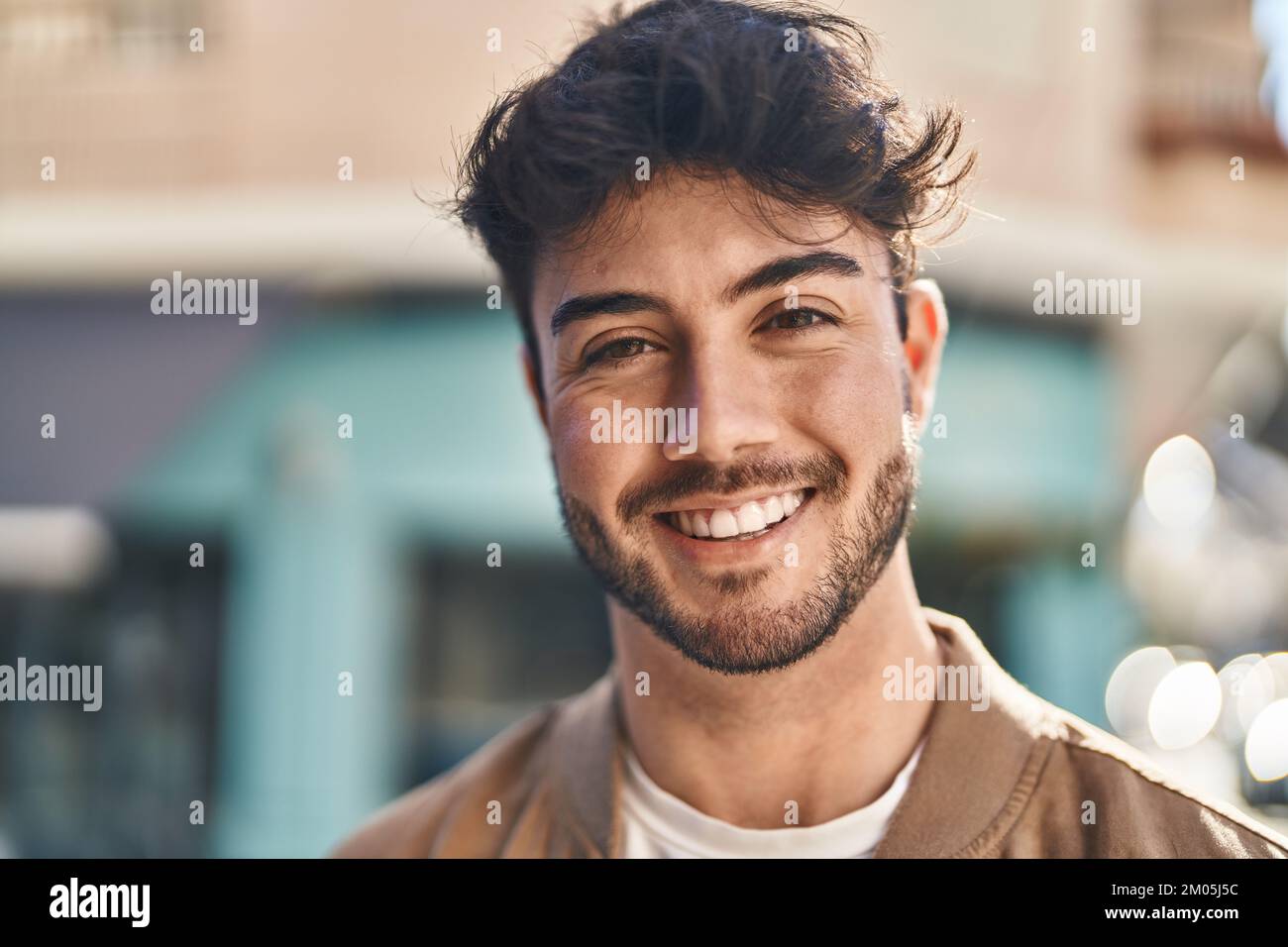Young hispanic man smiling confident standing at street Stock Photo - Alamy