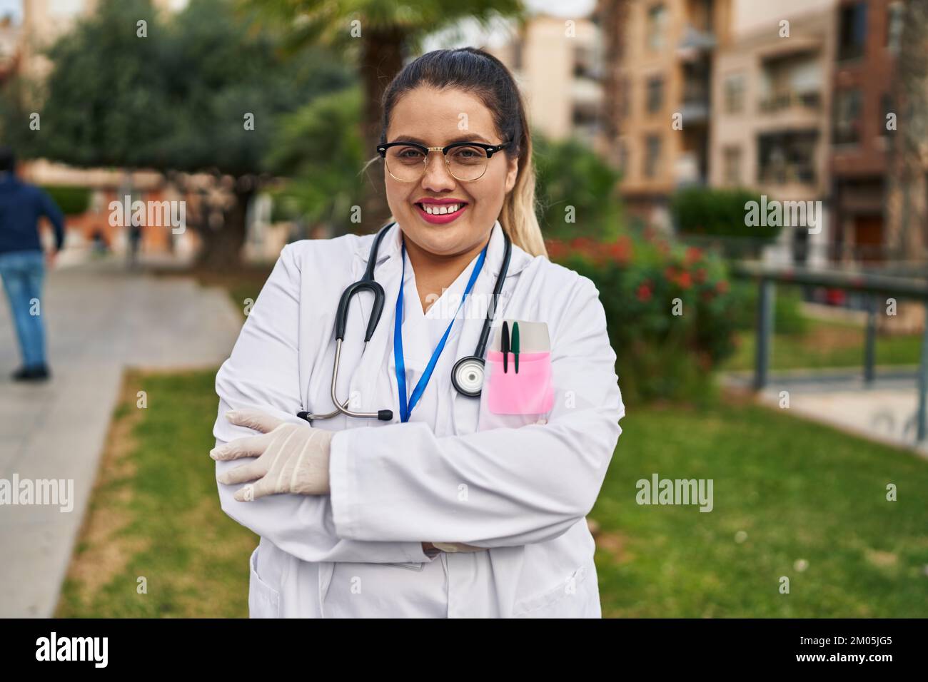 Young beautiful plus size woman doctor smiling confident standing with ...