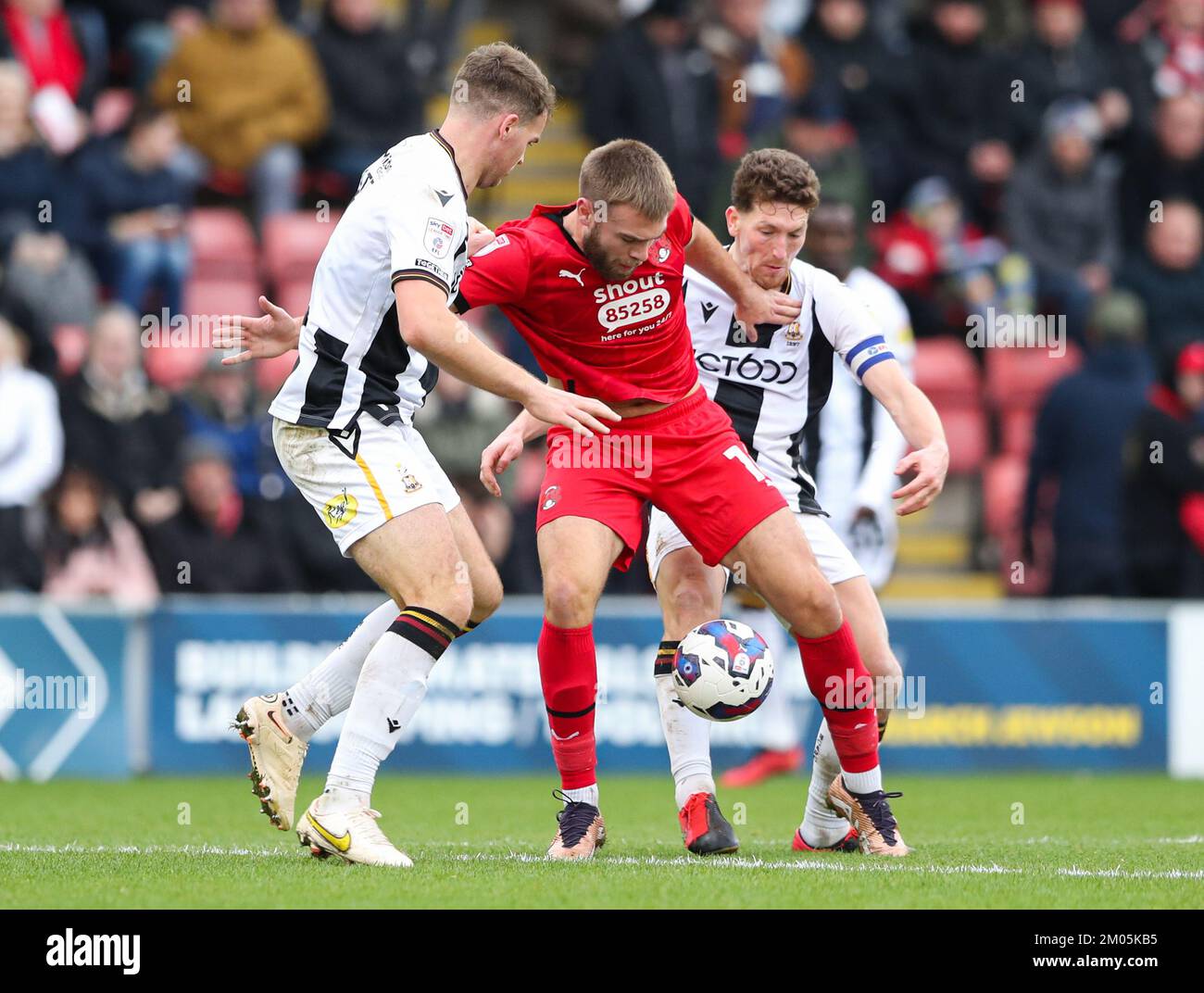 Leyton Orient's Aaron Drinan (centre) battles for the ball with ...