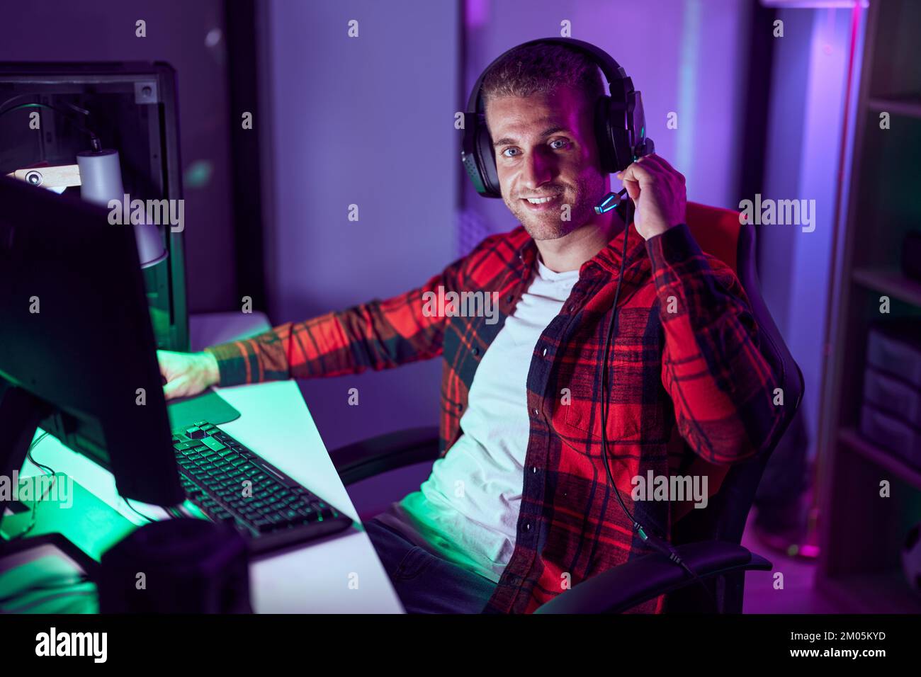 Young caucasian man streamer playing video game using computer at ...
