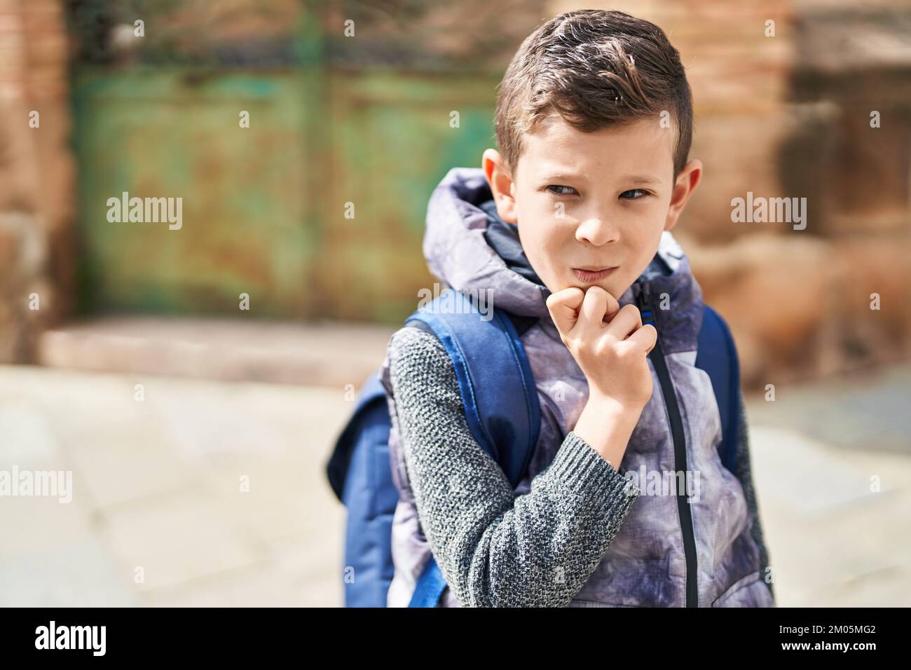 Blond child student standing with doubt expression at street Stock ...