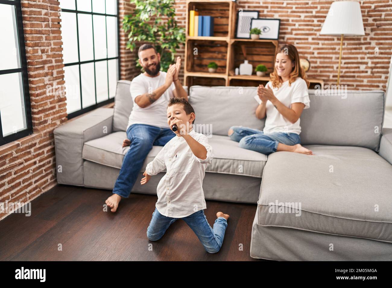 Family singing song using microphone at home Stock Photo - Alamy