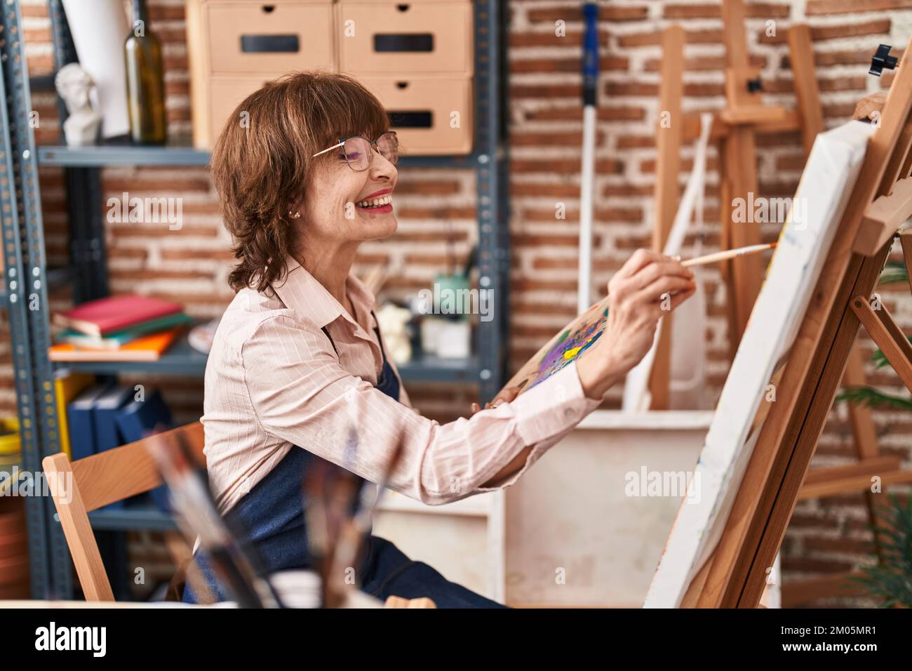 Middle age woman artist smiling confident drawing at art studio Stock ...