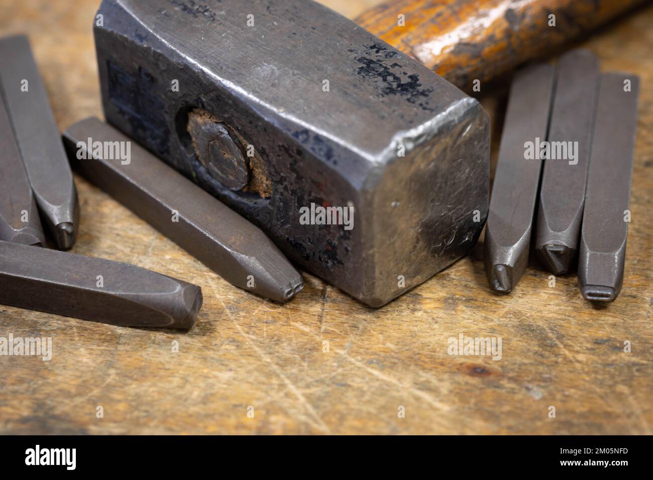 hammer and punch numbers on a work bench Stock Photo - Alamy