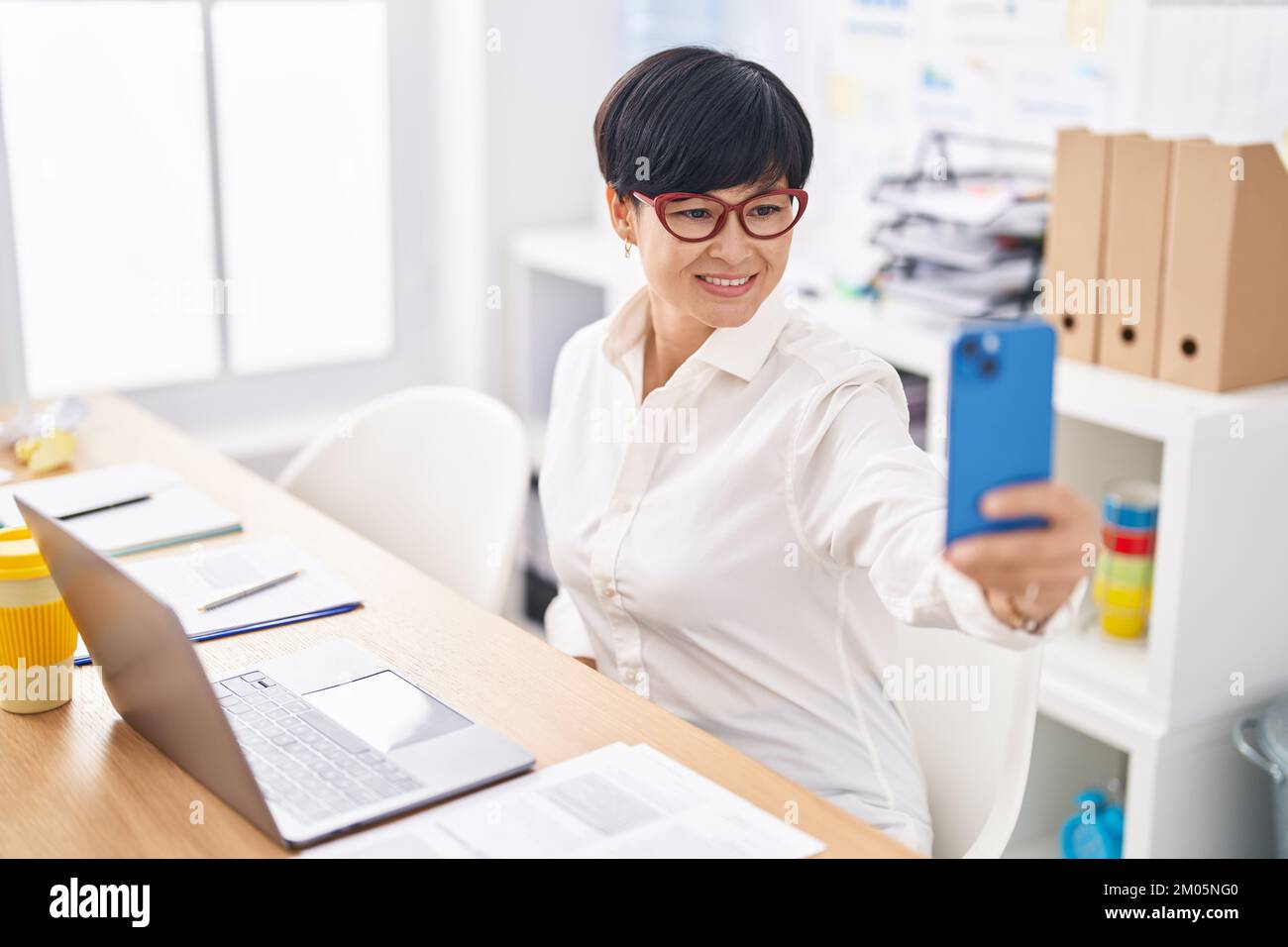 Middle age chinese woman business worker make selfie by smartphone at ...