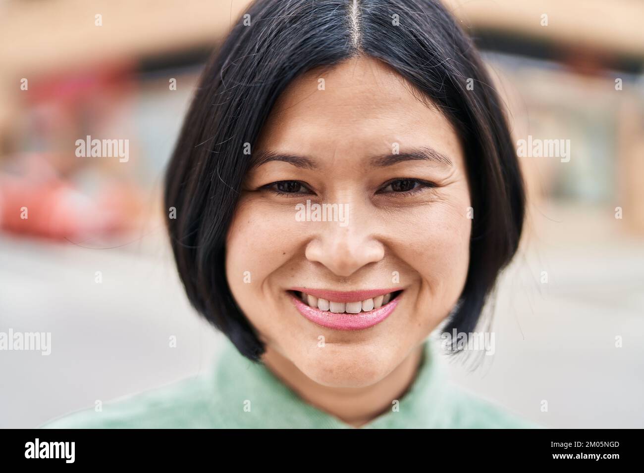 Young chinese woman smiling confident standing at street Stock Photo ...
