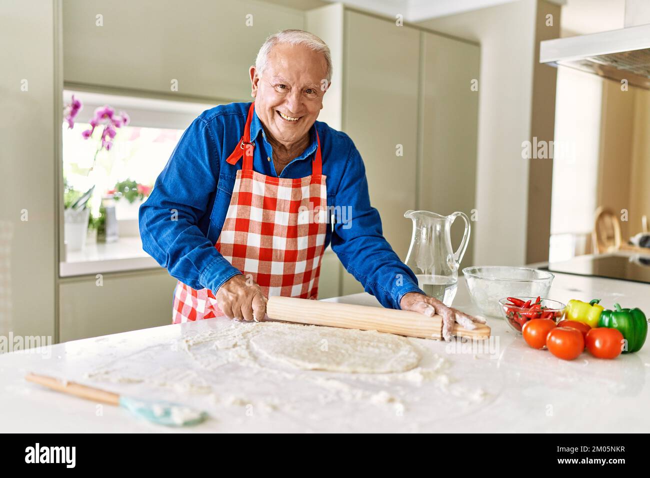 Senior man smiling confident keading pizza dough at kitchen Stock Photo ...