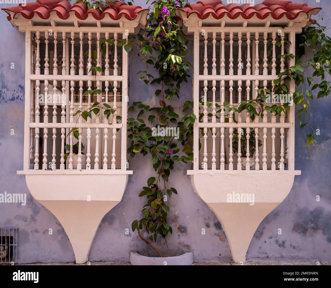 White colonial windows with wooden bars on blue building in Cartagena ...