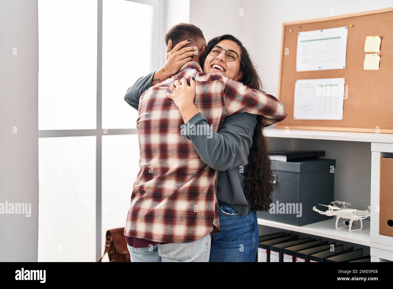 Man and woman business workers hugging each other at office Stock Photo ...