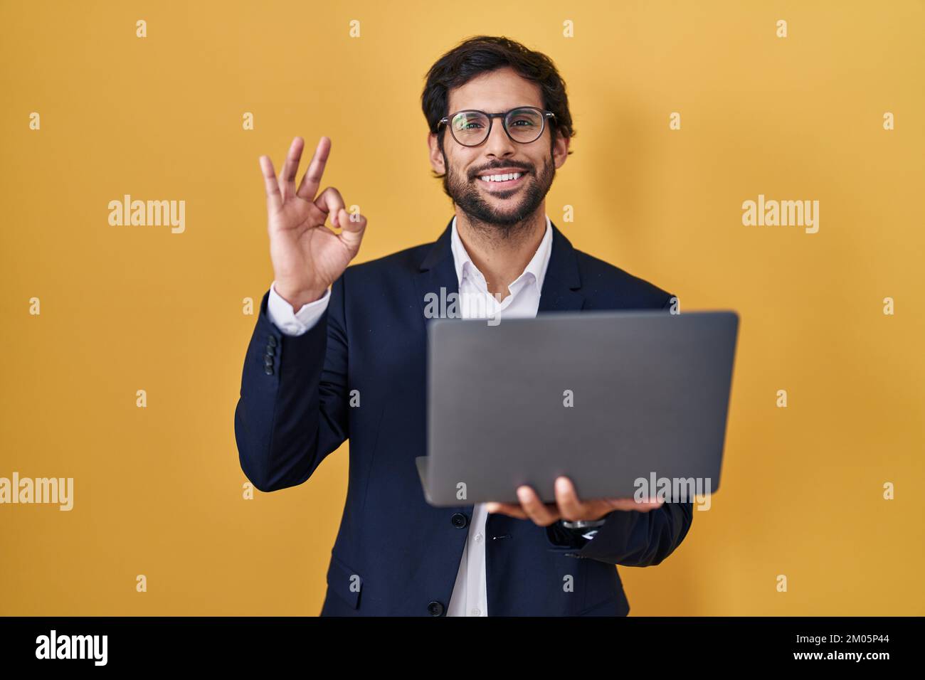 Handsome latin man working using computer laptop smiling positive doing ...