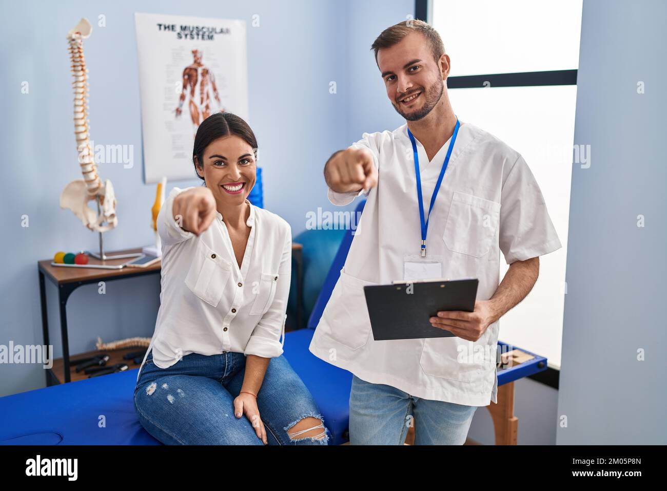 Young hispanic woman at physiotherapist appointment pointing to you and ...