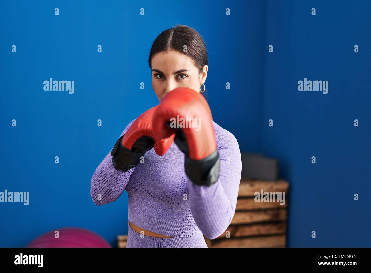 Young beautiful hispanic woman boxing at sport center Stock Photo - Alamy