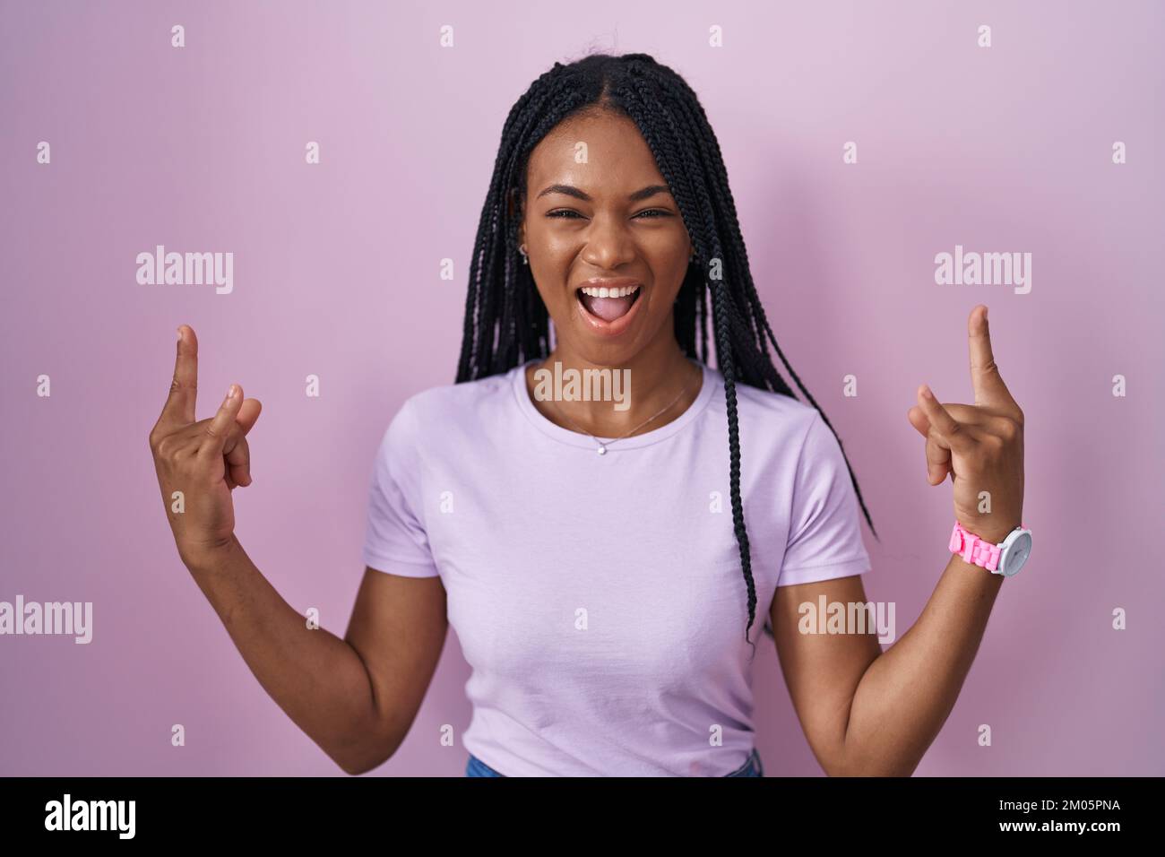 African american woman with braids standing over pink background ...