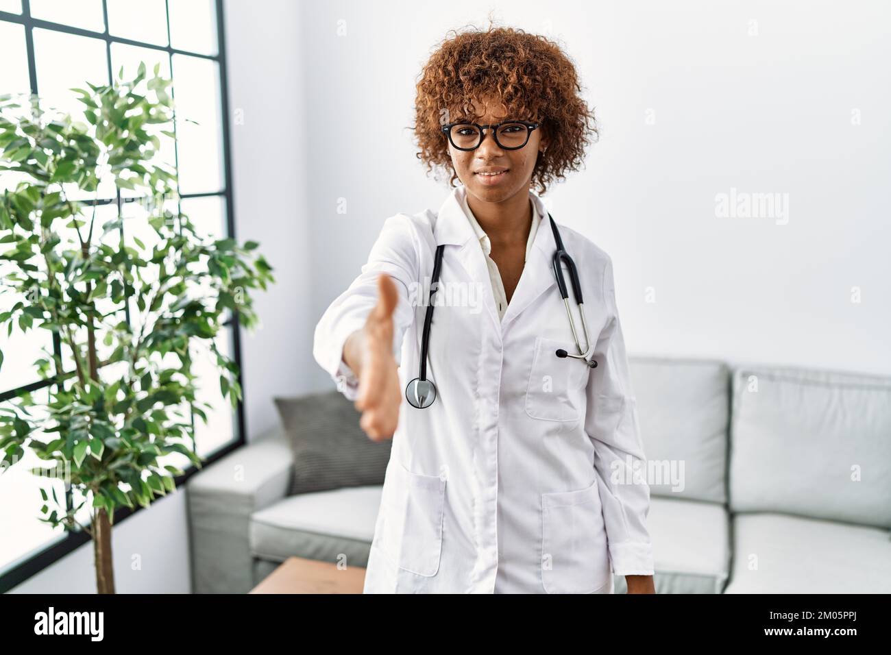 Young african american woman wearing doctor uniform and stethoscope ...