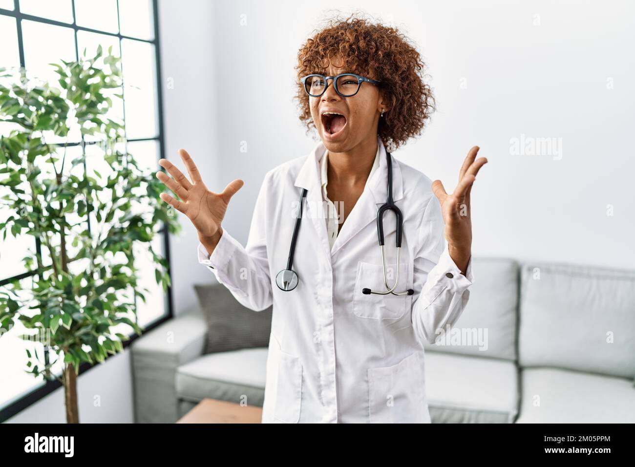 Young african american woman wearing doctor uniform and stethoscope ...