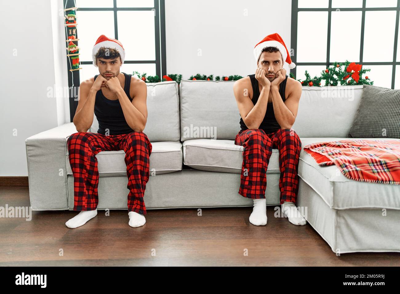 Two hispanic men couple arguing sitting by christmas tree at home Stock ...