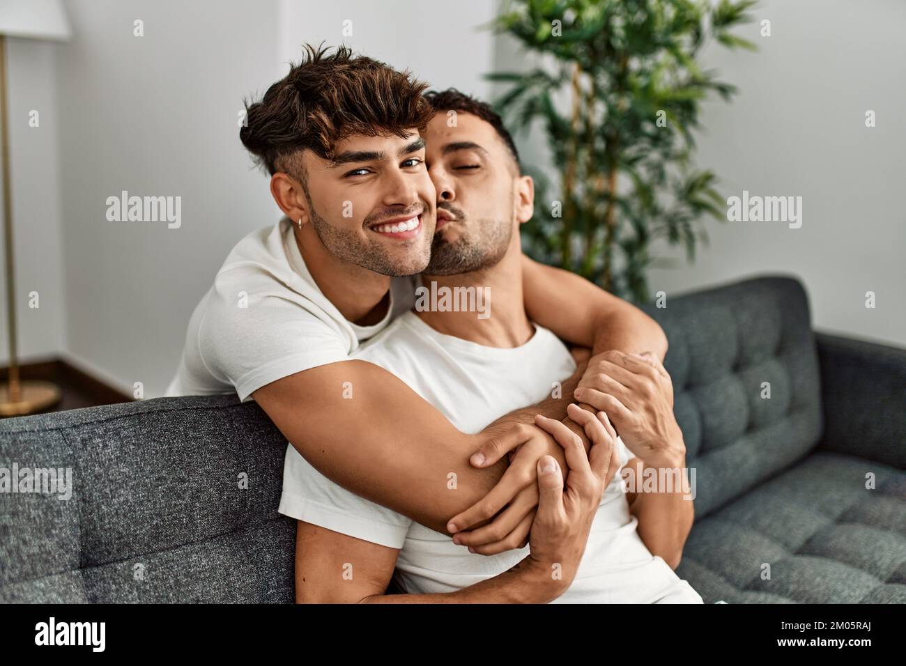 Two hispanic men couple smiling confident and hugging each other at ...