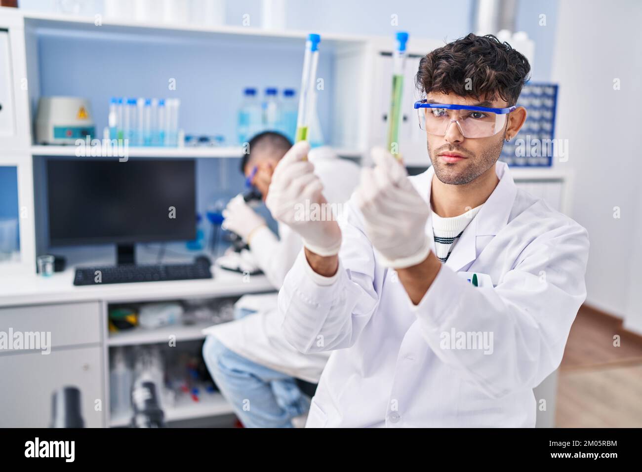 Two man scientists holding test tubes working at laboratory Stock Photo ...