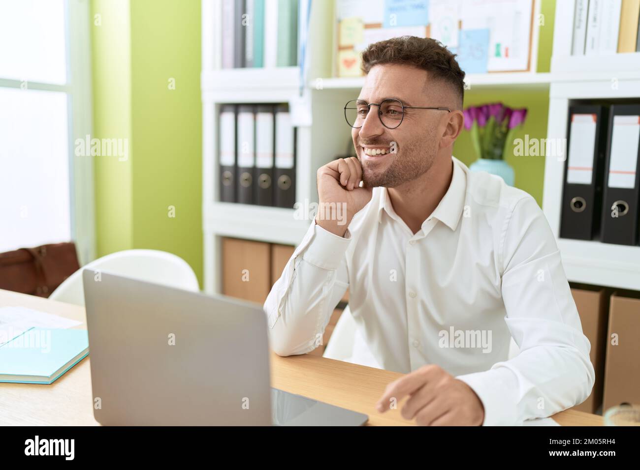 Young hispanic man business worker using laptop working at office Stock ...
