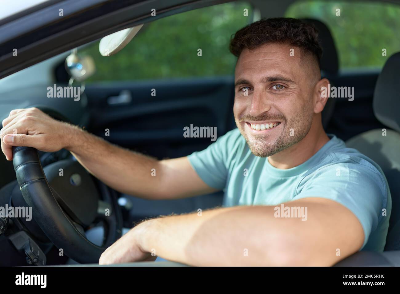 Young hispanic man smiling confident driving car at street Stock Photo ...