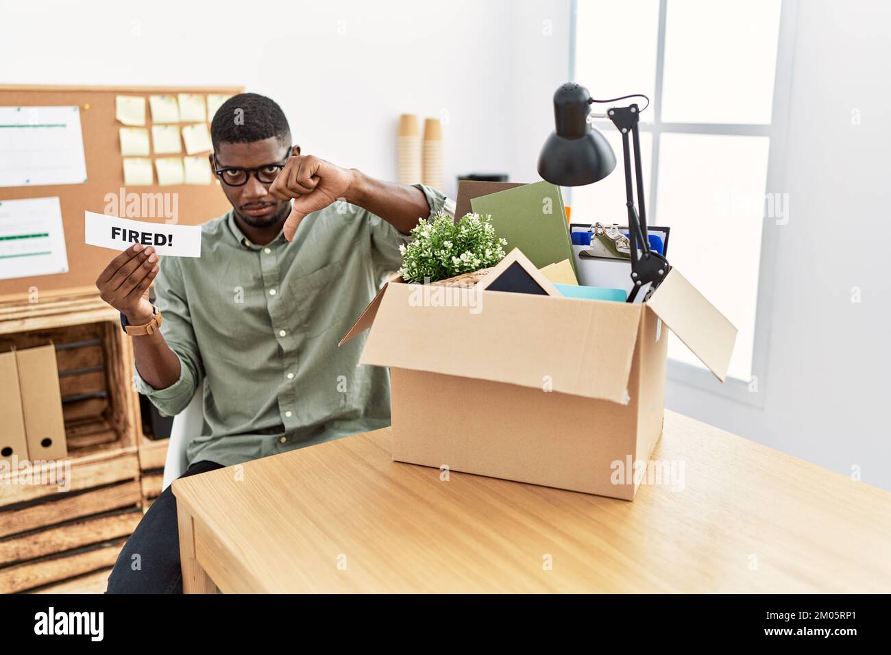 Young african american businessman holding fired banner at the office ...