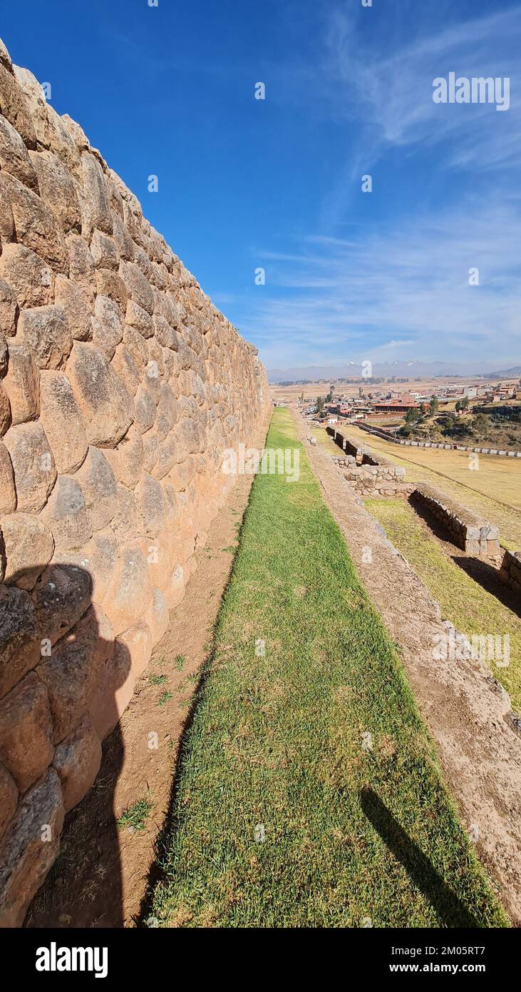 an Inca stone building with a mountain in the background in Peru Stock ...