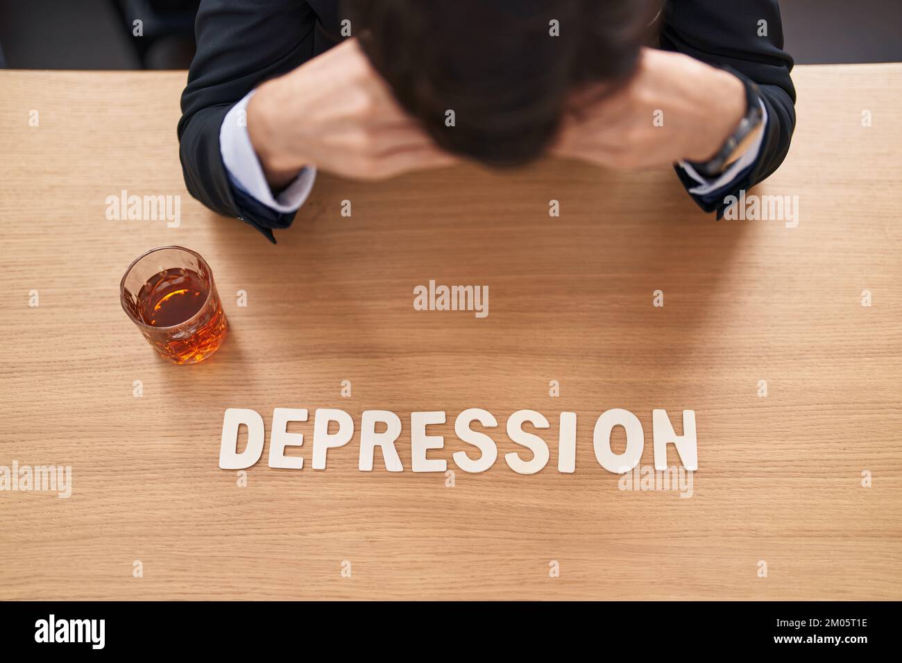 Young hispanic man business worker sitting on table with depression ...