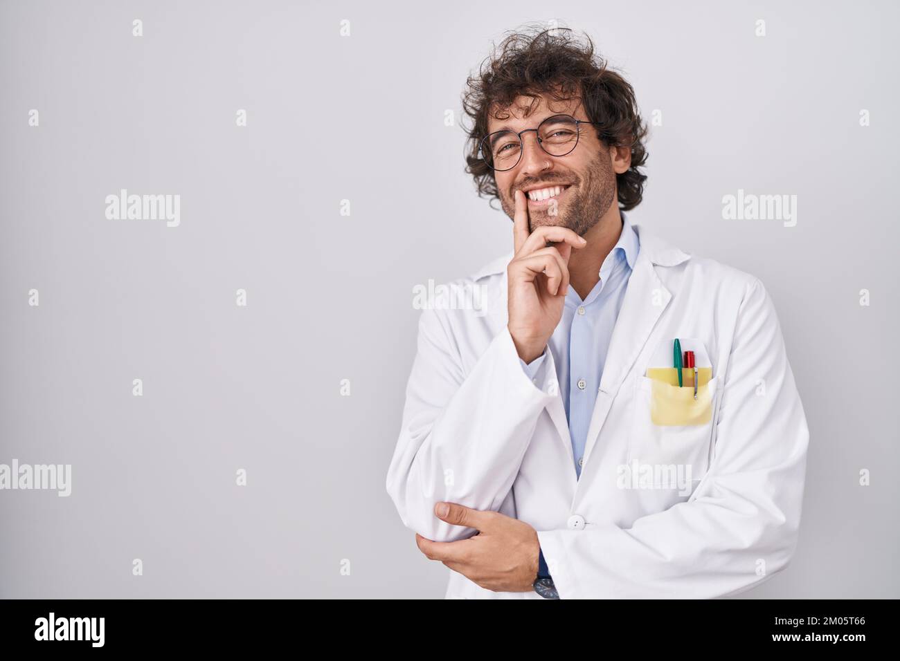 Hispanic young man wearing doctor uniform looking confident at the ...