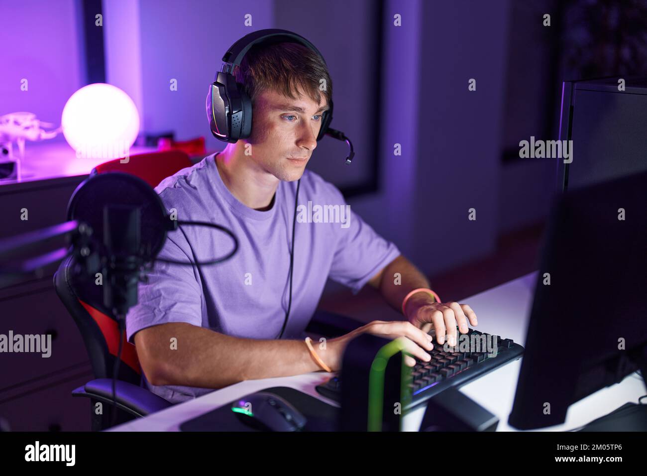 Young caucasian man streamer playing video game using computer at ...