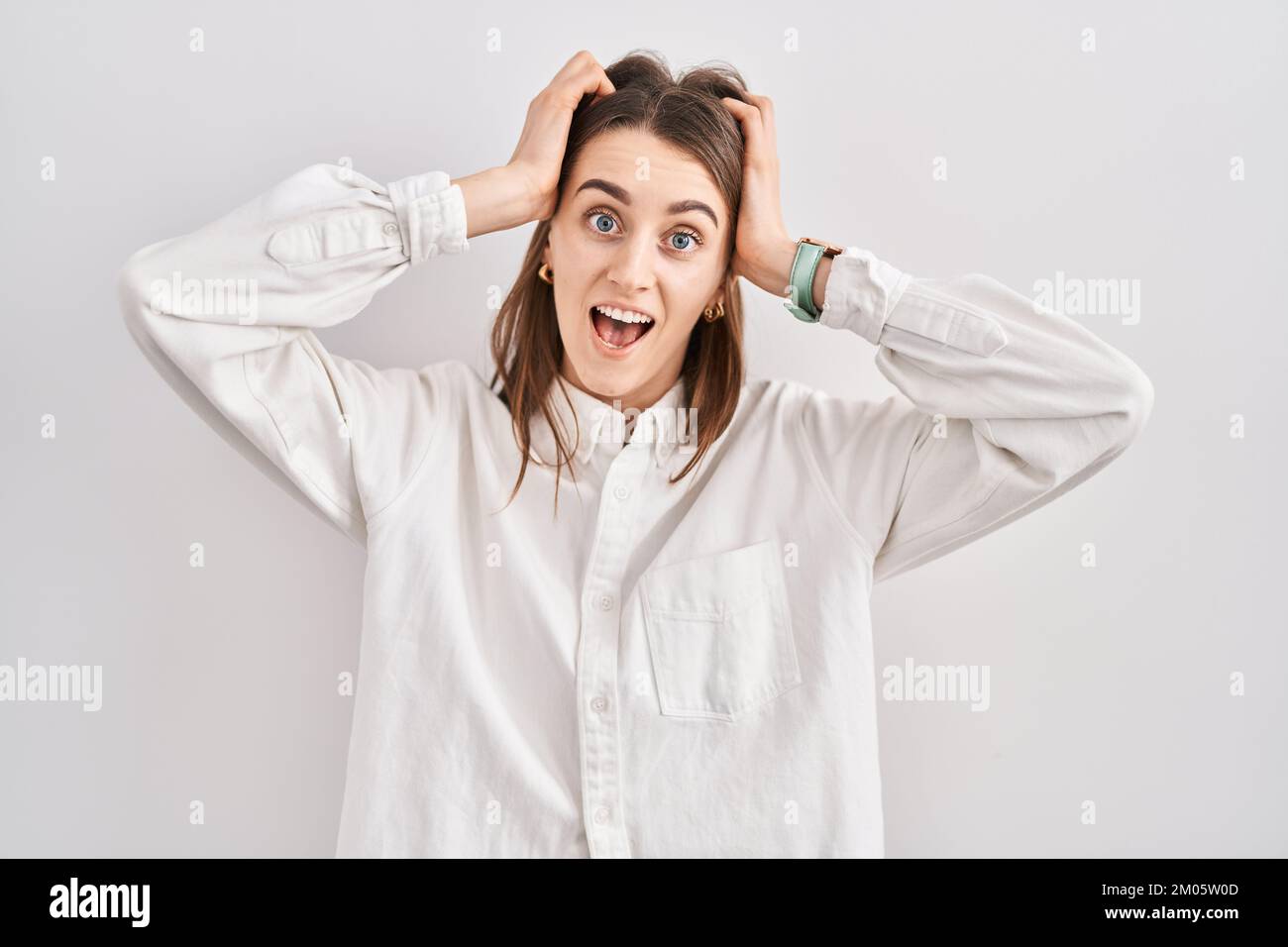 Young caucasian woman standing over isolated background crazy and ...