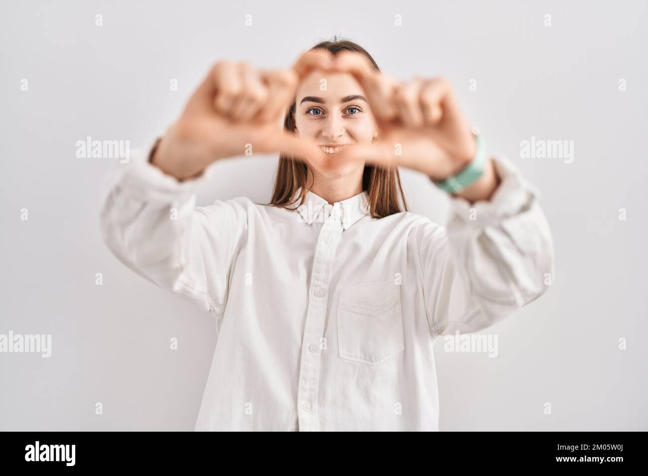 Young caucasian woman standing over isolated background smiling in love ...