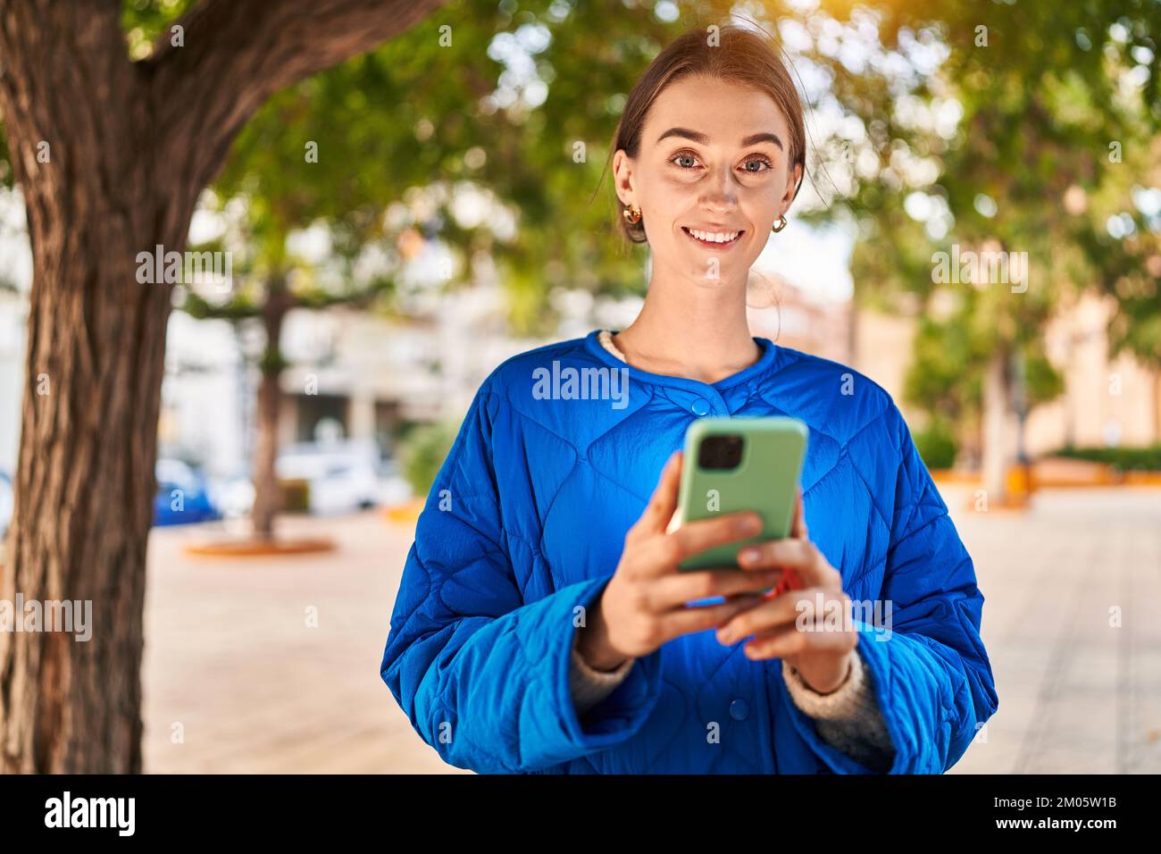 Young caucasian woman smiling confident using smartphone at park Stock ...