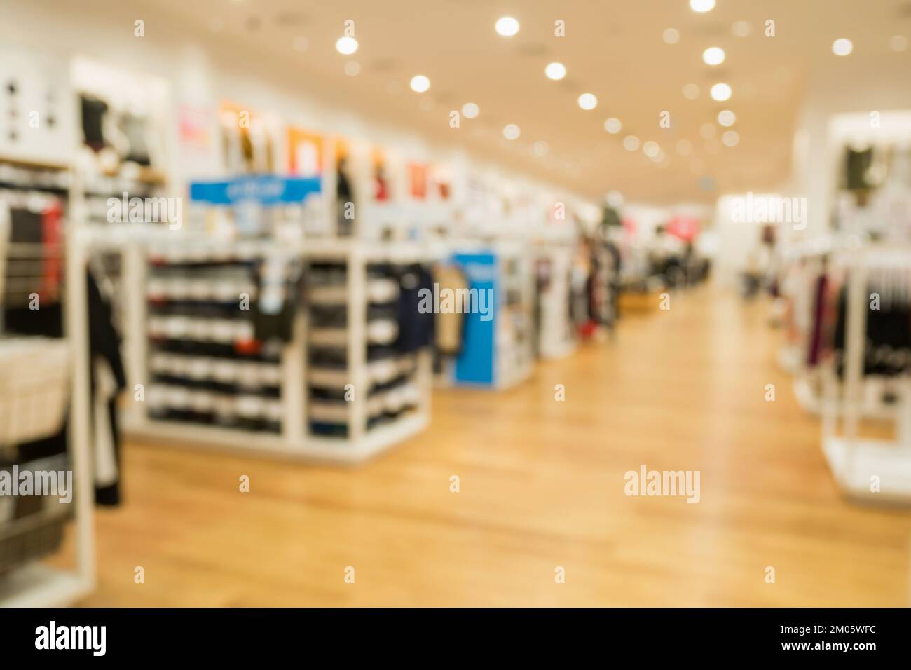 Abstract blurred fashion clothing store in modern shopping mall ...