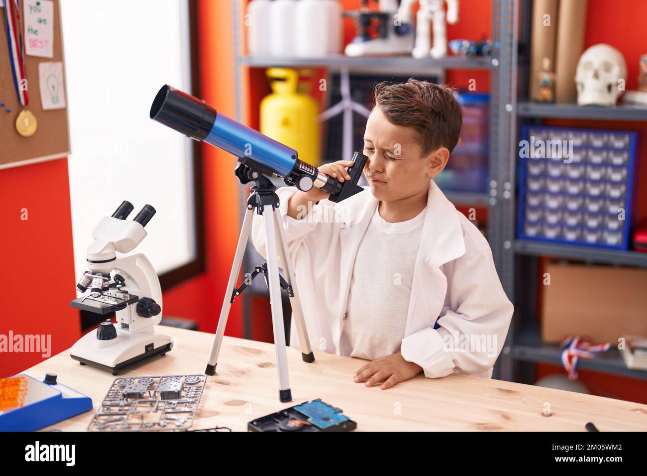 Adorable hispanic toddler student using telescope at classroom Stock ...