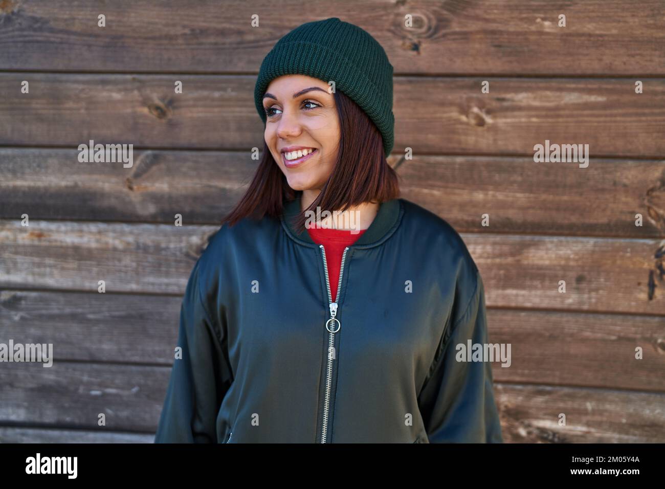 Young beautiful hispanic woman smiling confident looking to the side ...