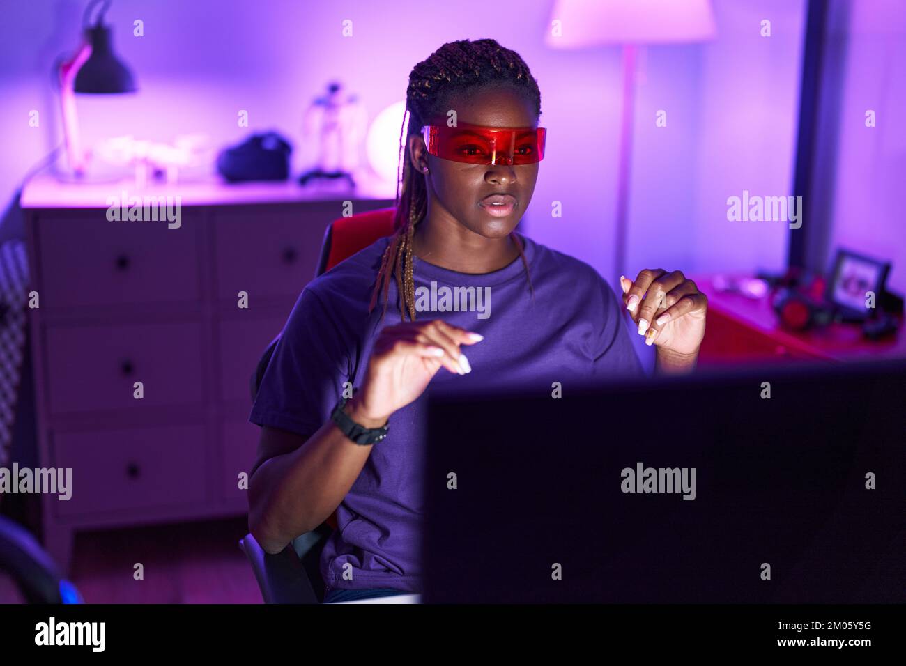 African american woman streamer playing video game using virtual ...